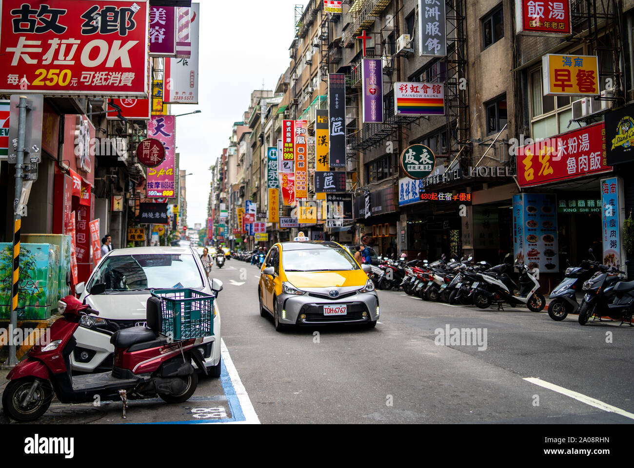 Taipei, Taiwan: Yellow Taiwanese Taxi on small urban street in Taipei ...