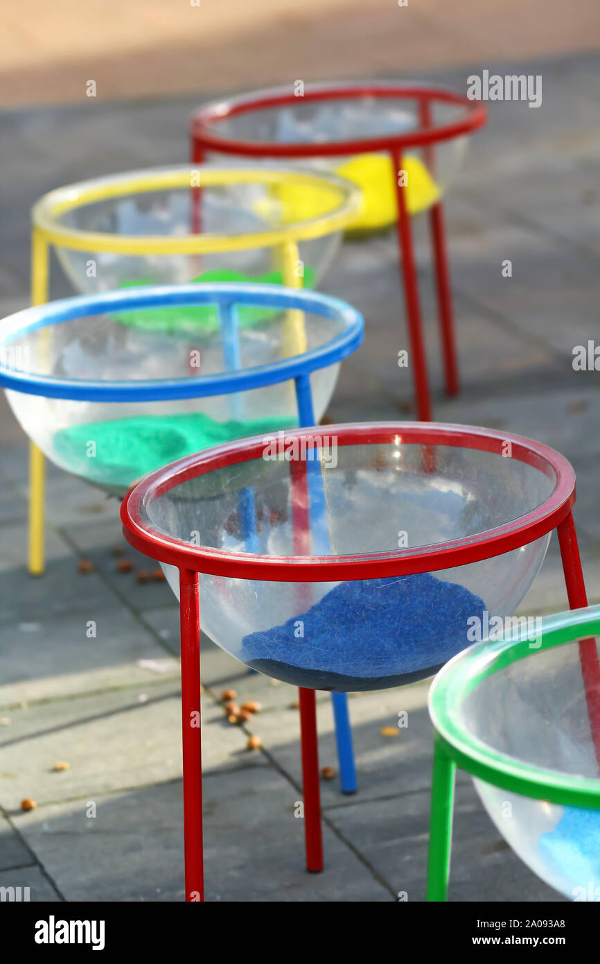 Plastic bowls with colorful sand for art therapy Stock Photo - Alamy