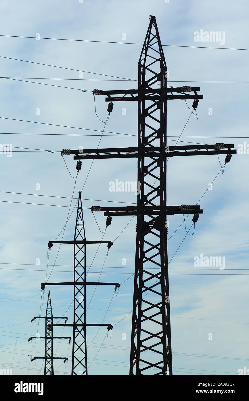 Row of high voltage power lines, electricity towers and pylons Stock ...