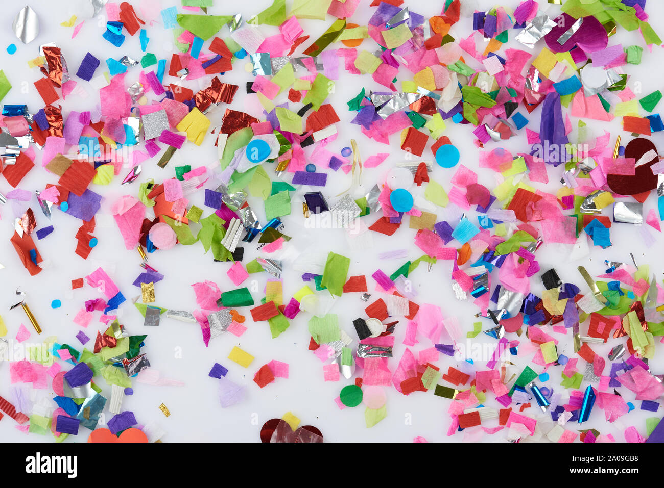 Colorful confetti pieces lay on top of white background Stock Photo - Alamy