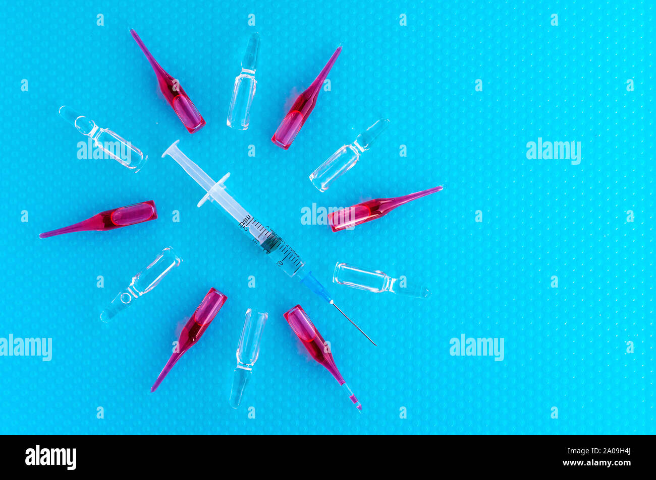 Syringe with a needle, red and white ampoules for injection. Medicine ...