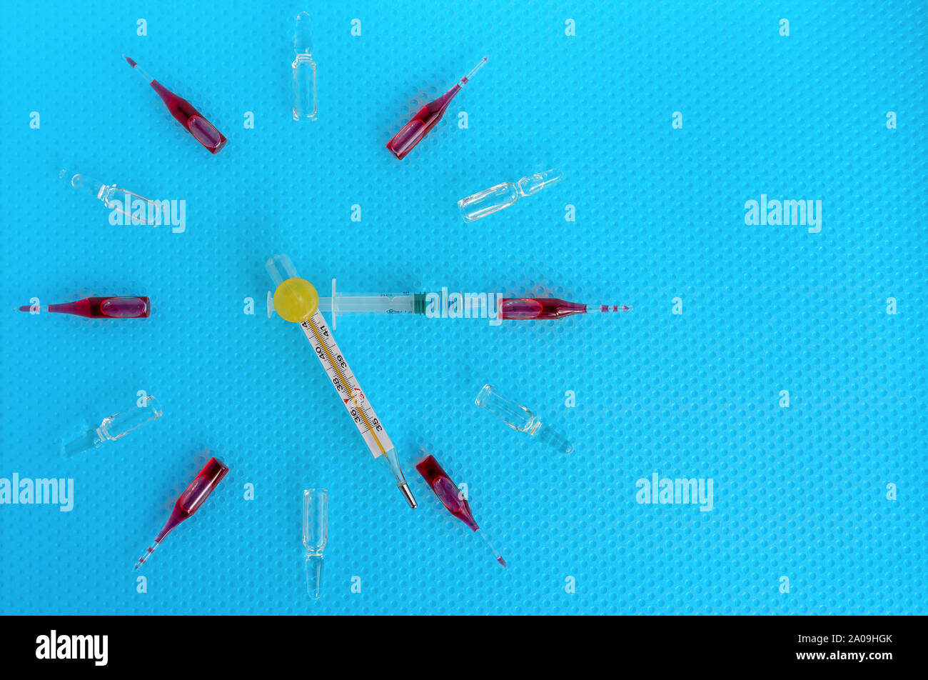 Medical watch made of ampoules, pills, thermometer and syringe. The ...