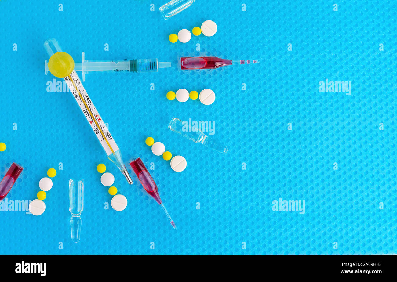 Medical watch made of ampoules, pills, thermometer and syringe. The ...