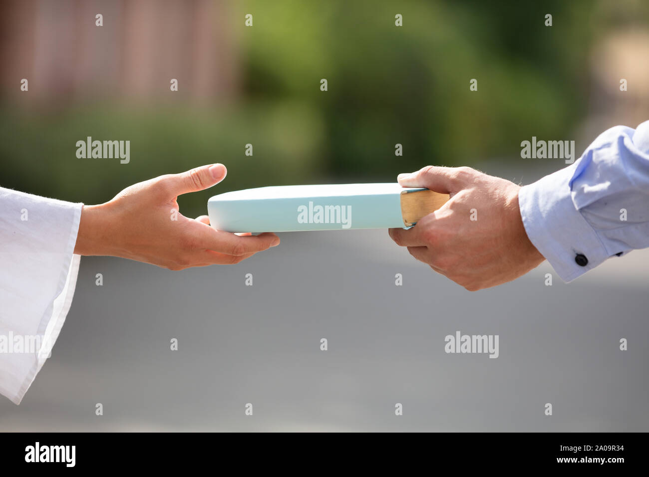 Handing woman books hi-res stock photography and images - Alamy