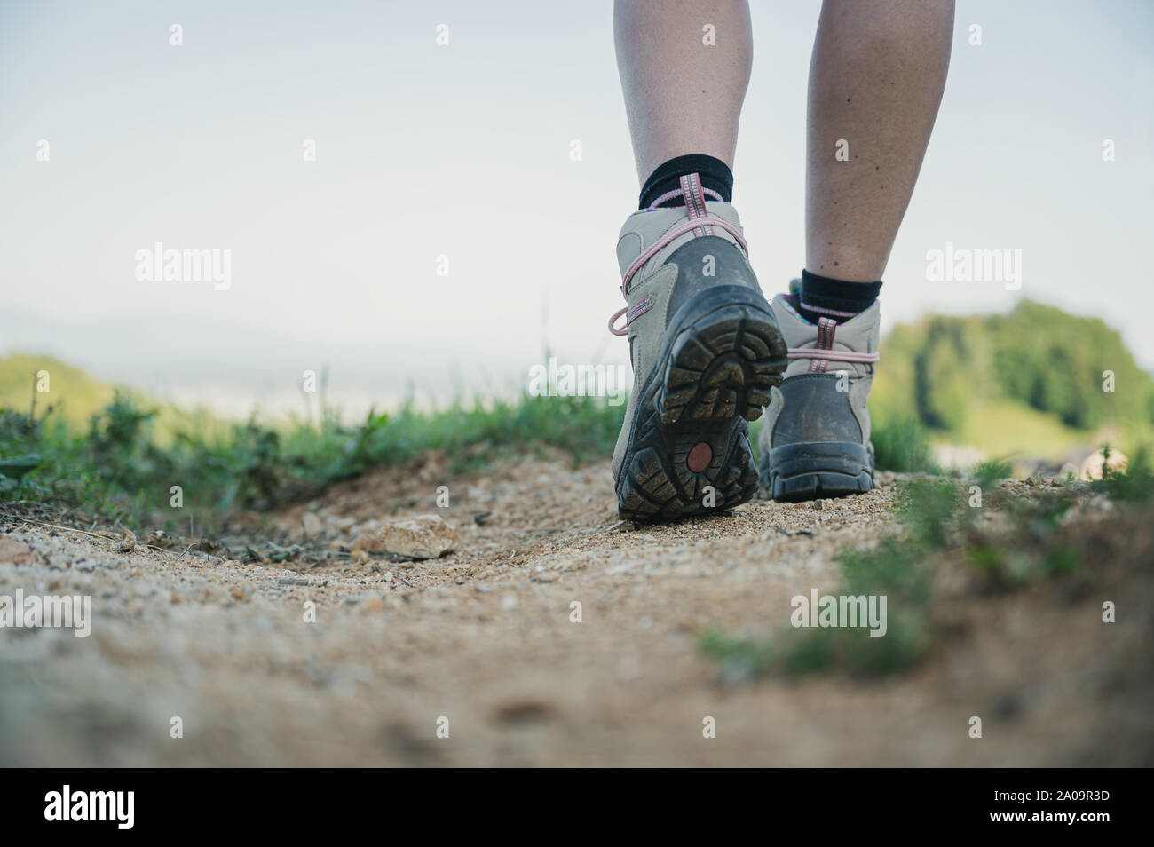 Low angle view of female hiker wearing hiking shoes standing on ...