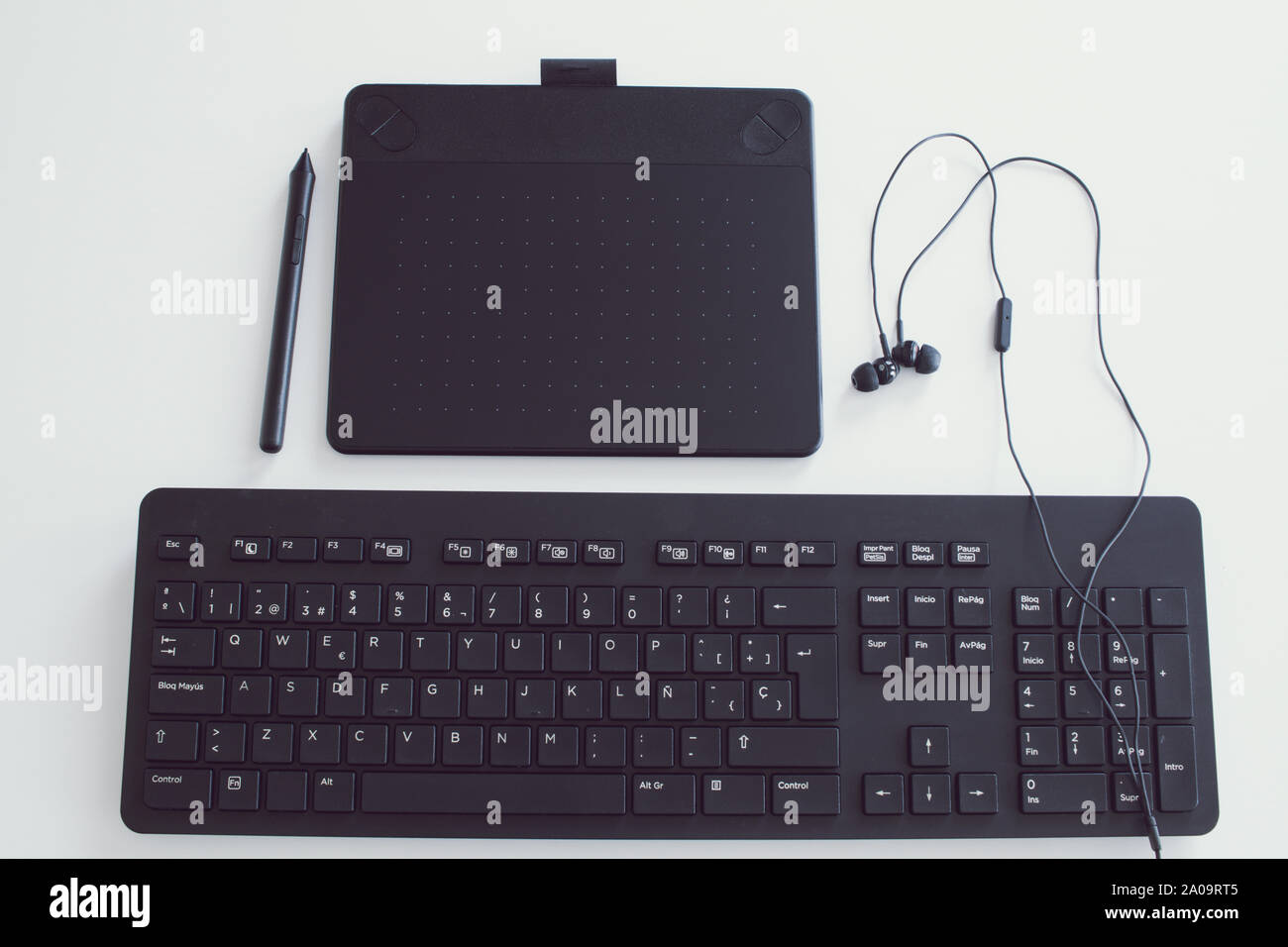 drawing tablet, earphones and keyboard Stock Photo - Alamy