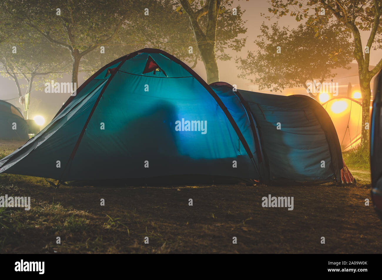 blue tent with person silhouette Stock Photo - Alamy
