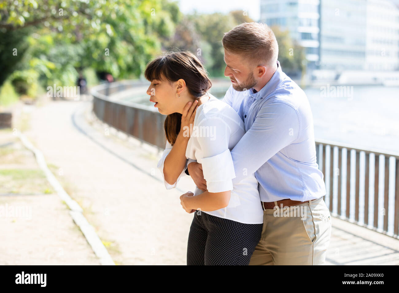 Man Helping Choking Woman To Expel A Trapped Object From Airway