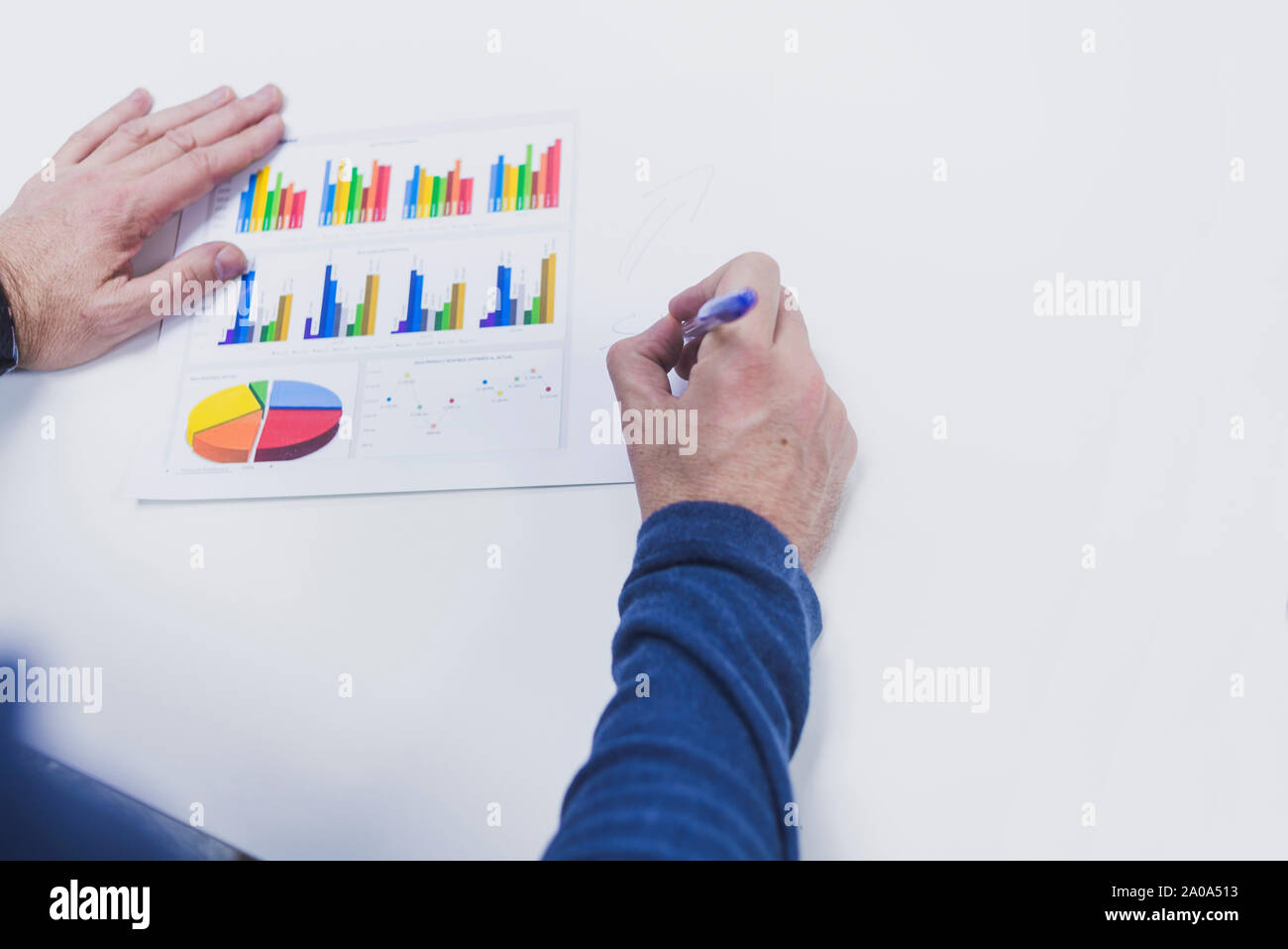 Overhead view of a hand writing in a chart Stock Photo - Alamy