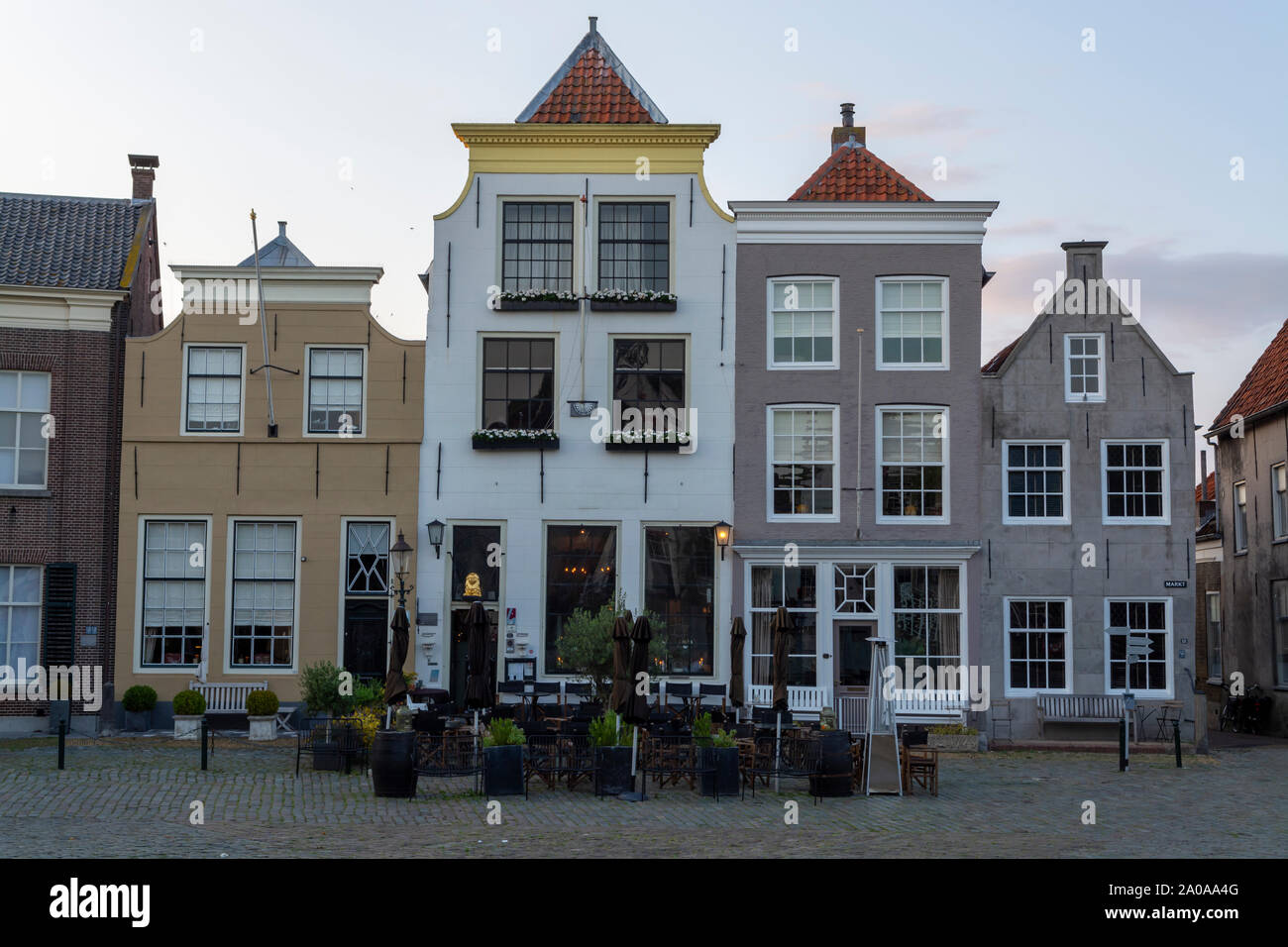 Street view with old houses in small Dutch town Goedereede on sunset ...