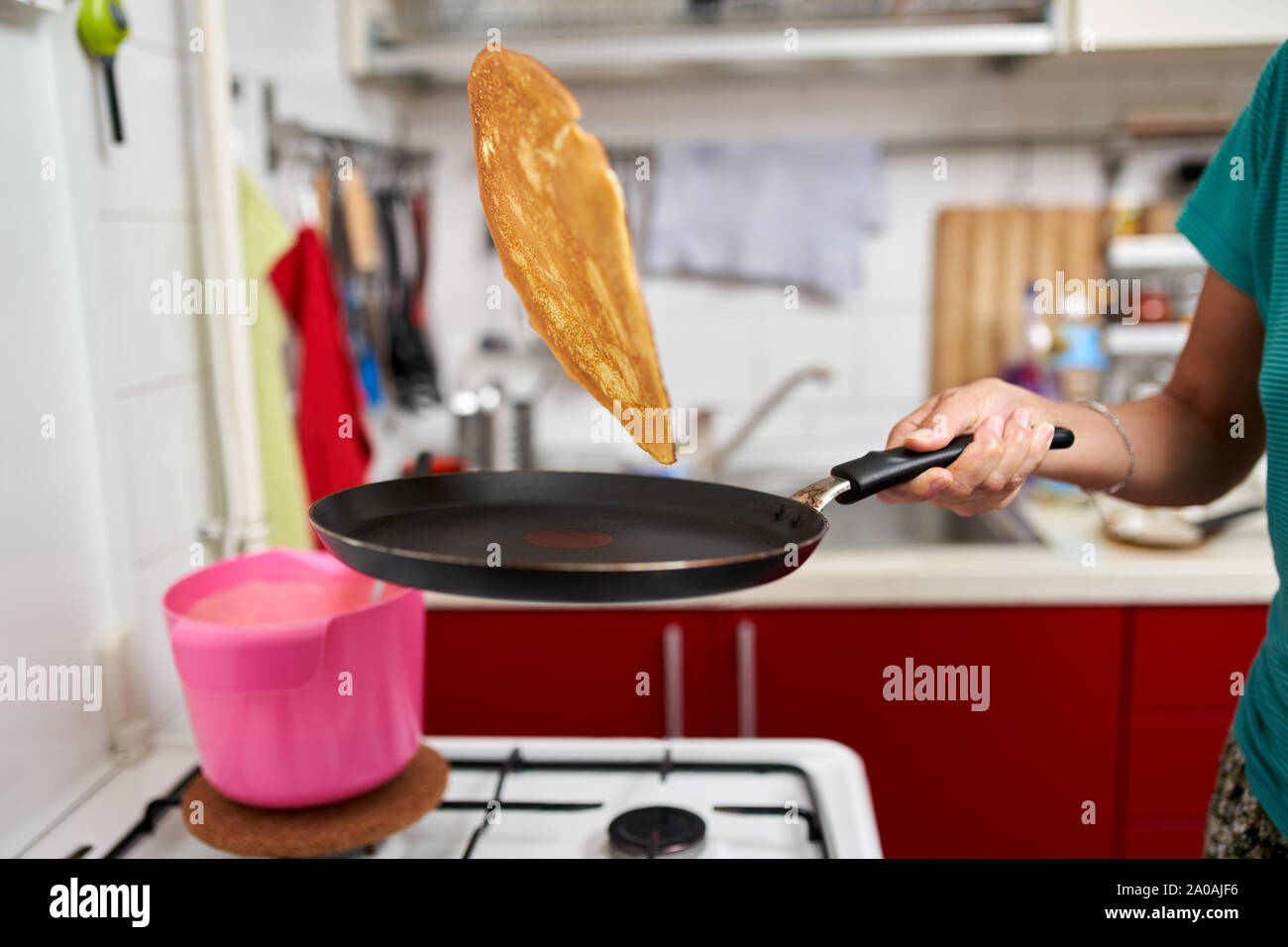 Woman cooking crepe tossing hi-res stock photography and images - Alamy