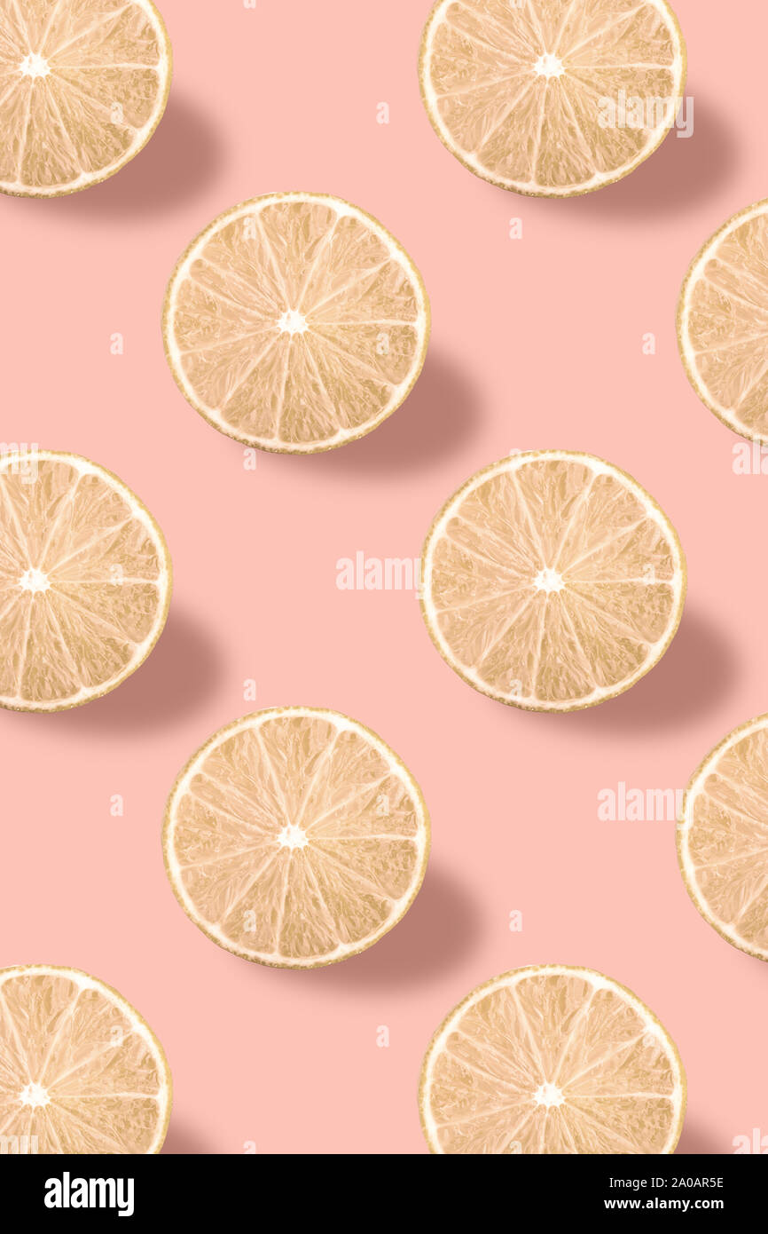 Colorful fresh slices lime texture on light pink background. From top ...