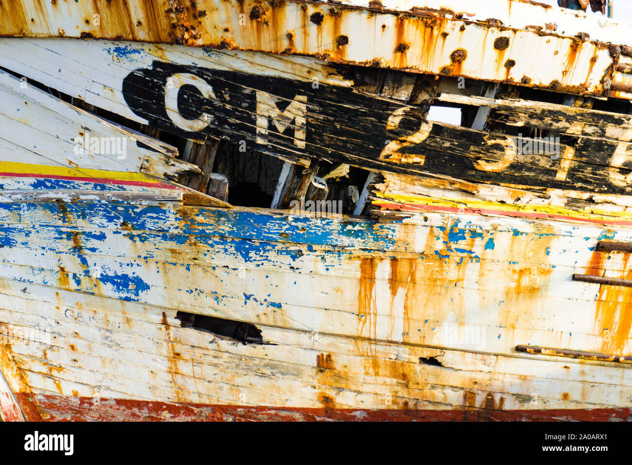 A close up view of a broken and cracked hull of an old wooden fishing ...