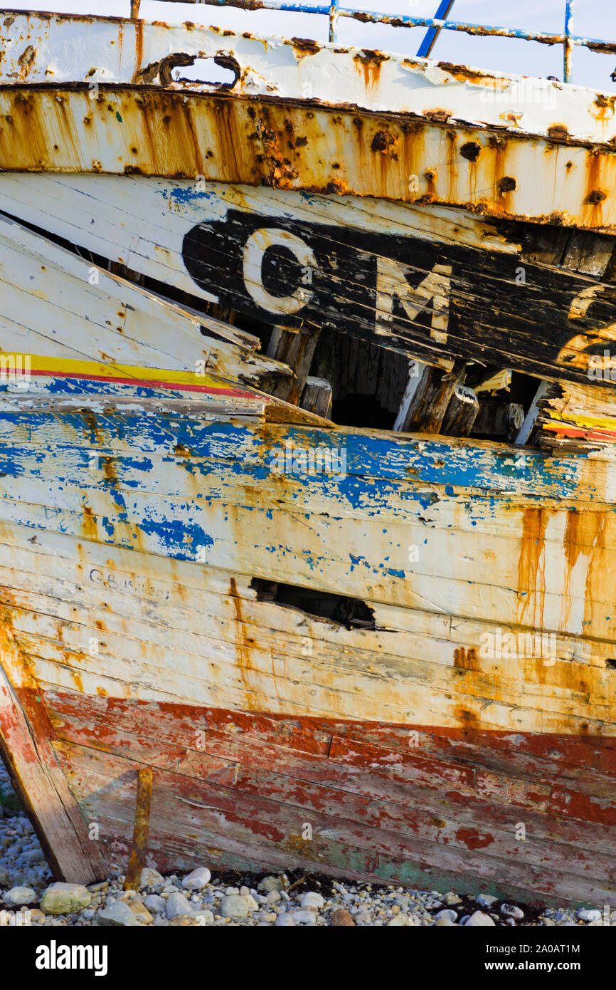 A close up view of a broken and cracked hull of an old wooden fishing ...