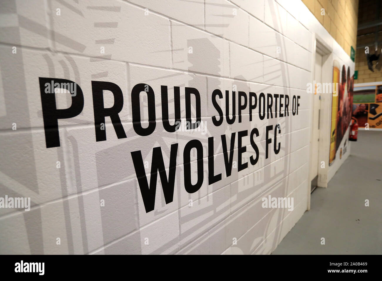 Signage inside the stadium reading "Proud Supporter of Wolves FC ...
