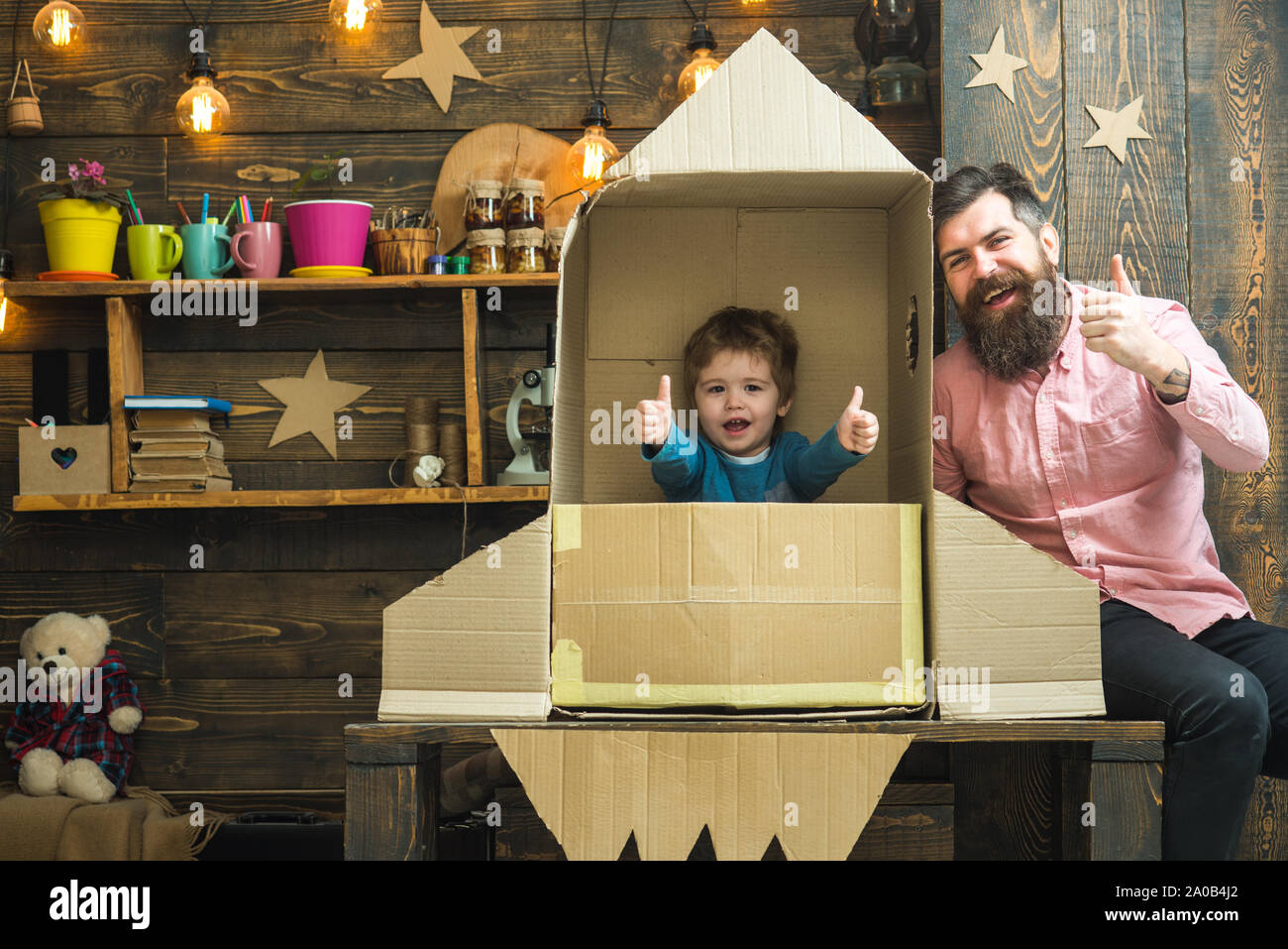 Rocket launch concept. Kid happy sit in hand made rocket. Boy play with ...