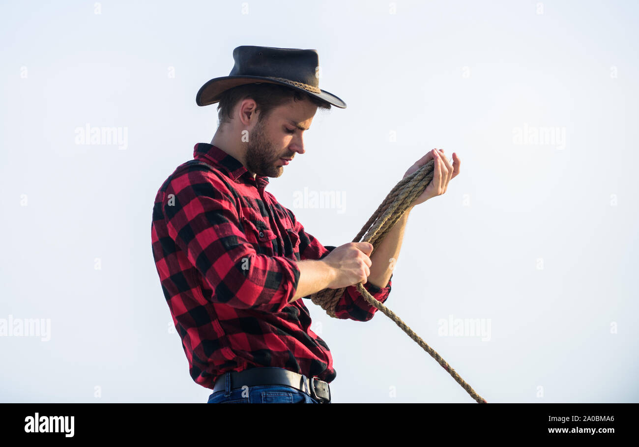 Ranch worker. Eco farm. Life at ranch. Cowboy with lasso rope sky ...