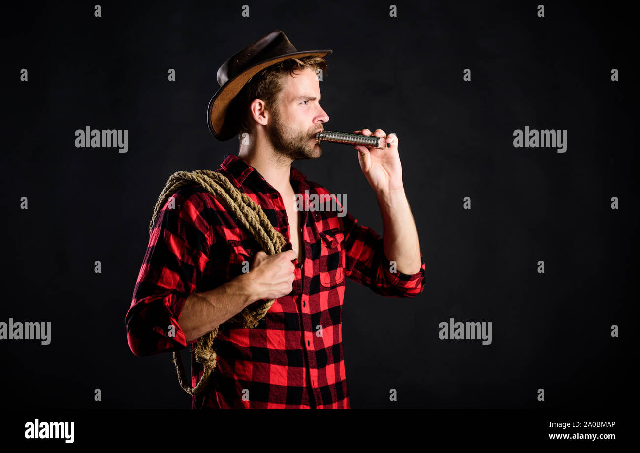 Sheriff concept. Brutal cowboy drinking alcohol. Western culture. Man ...