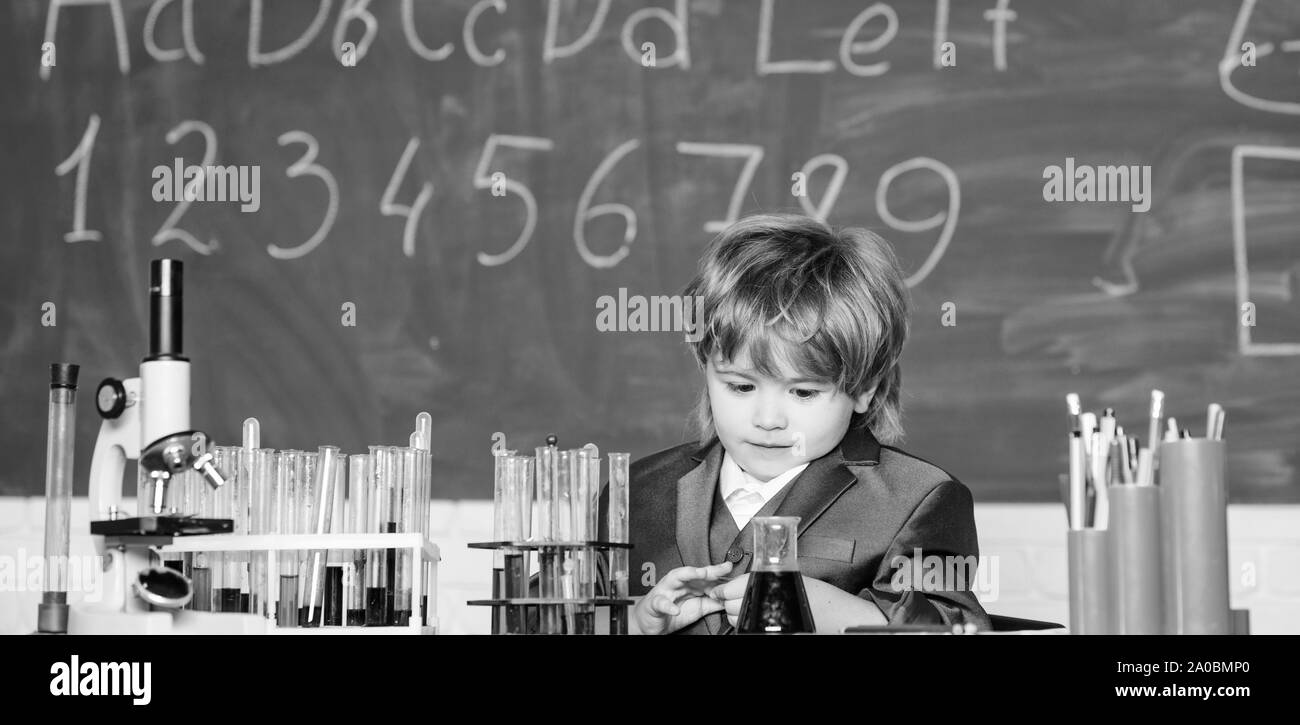 small boy study chemistry. small boy using microscope at school lesson ...