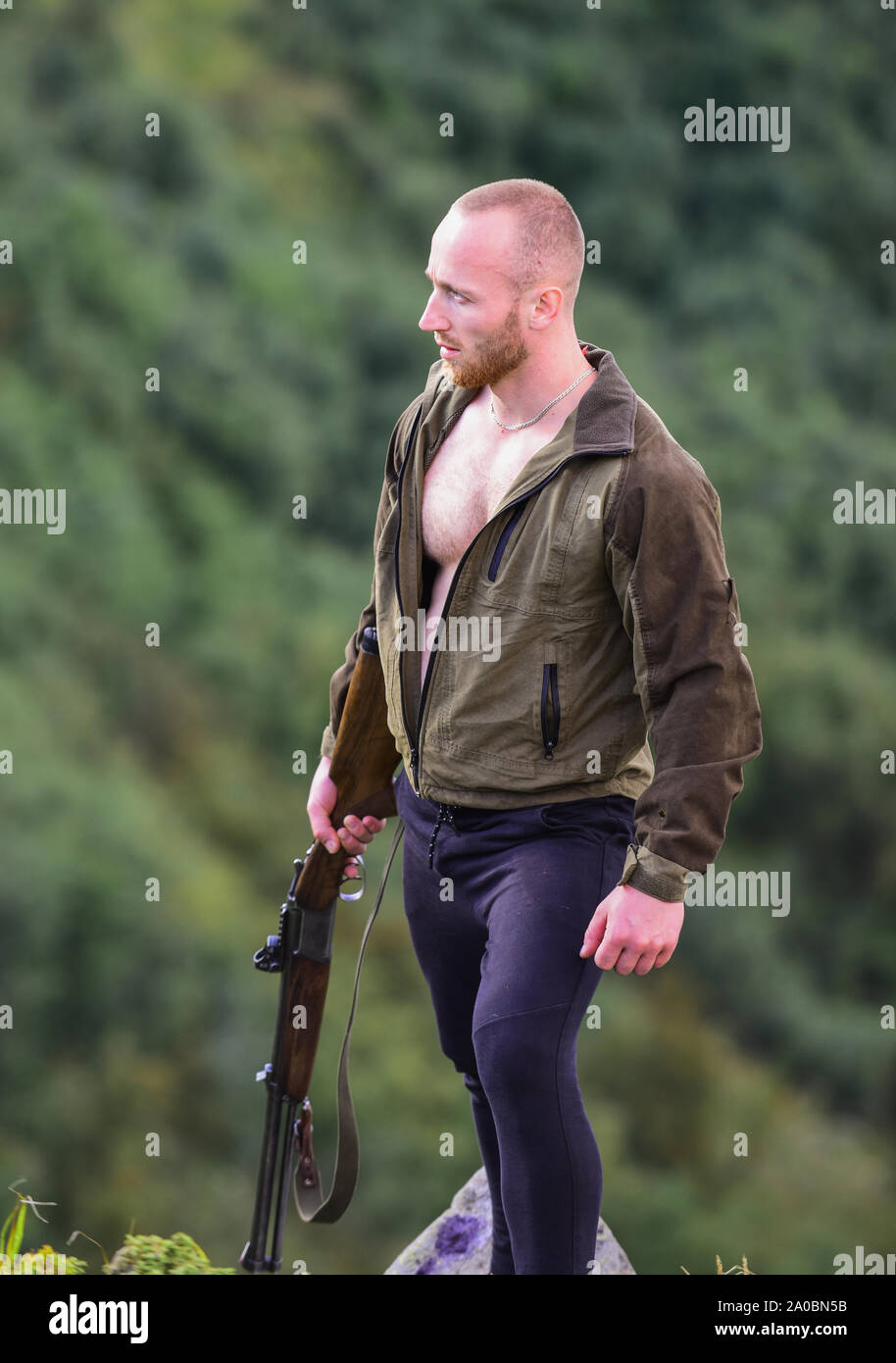 Illegal hunting. Man brutal poacher with weapon natural landscape ...