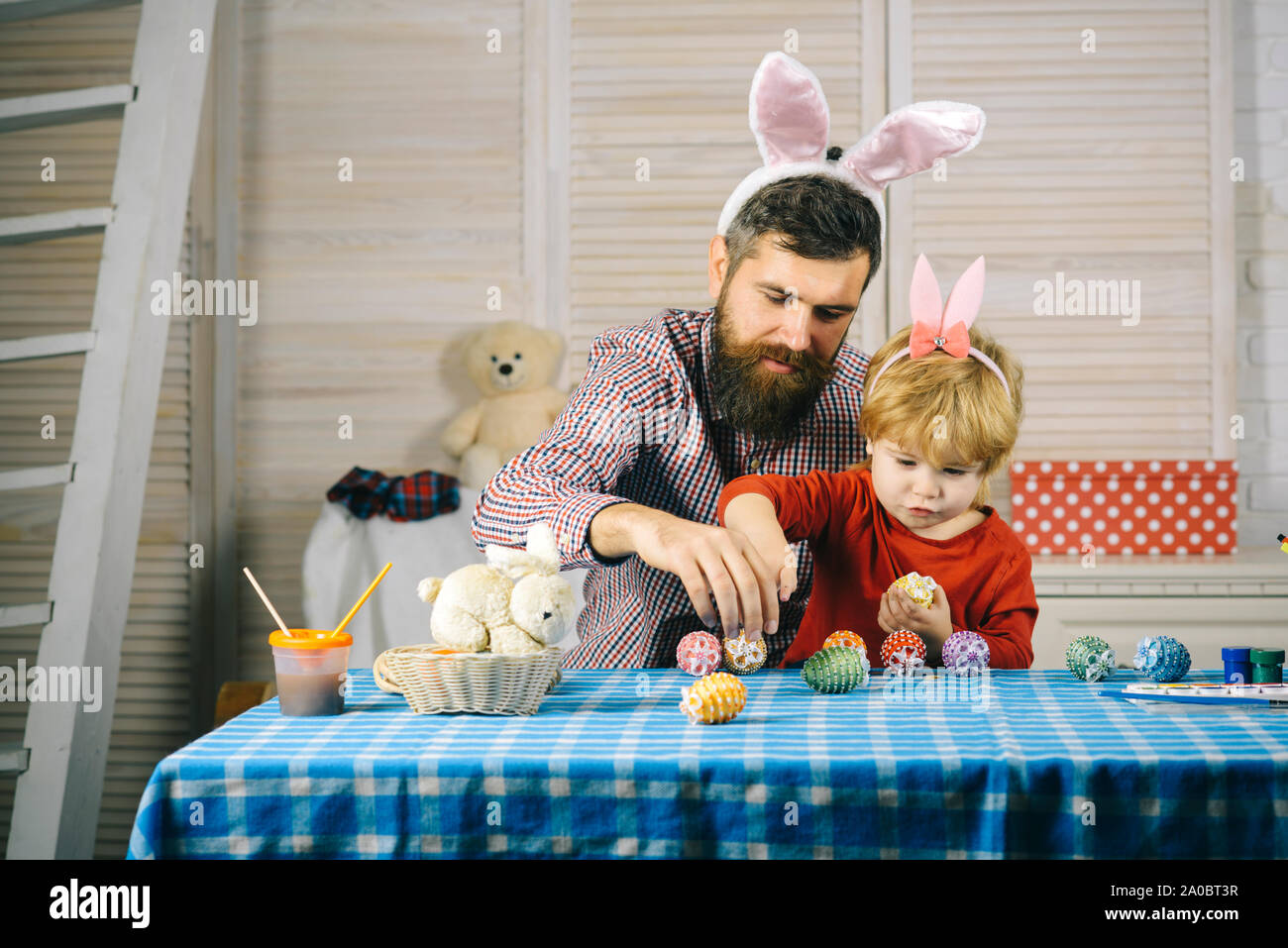 father man with son preparing eggs for Easter Stock Photo - Alamy