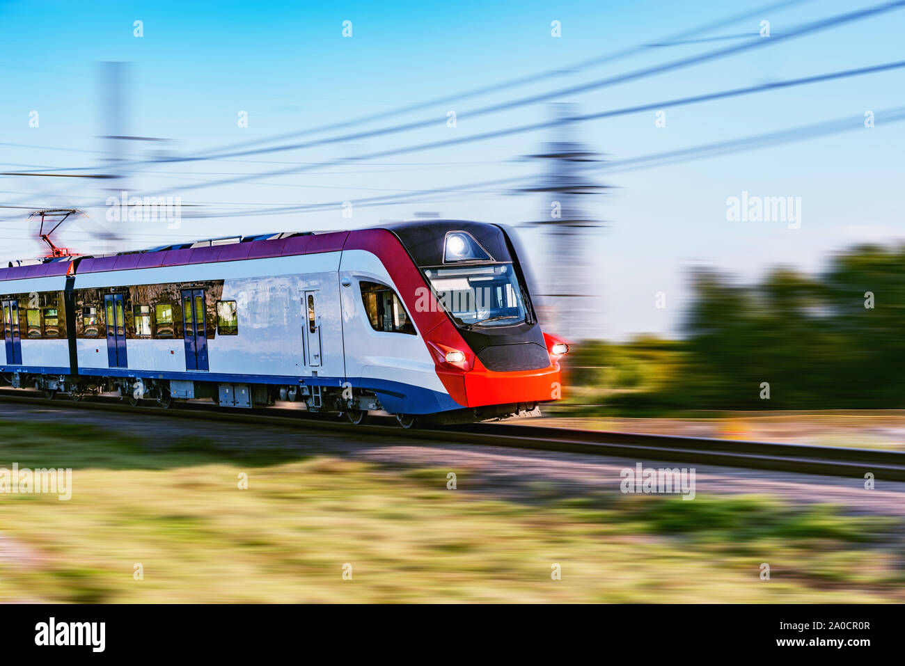 Modern high-speed train moves fast sunny day time Stock Photo - Alamy