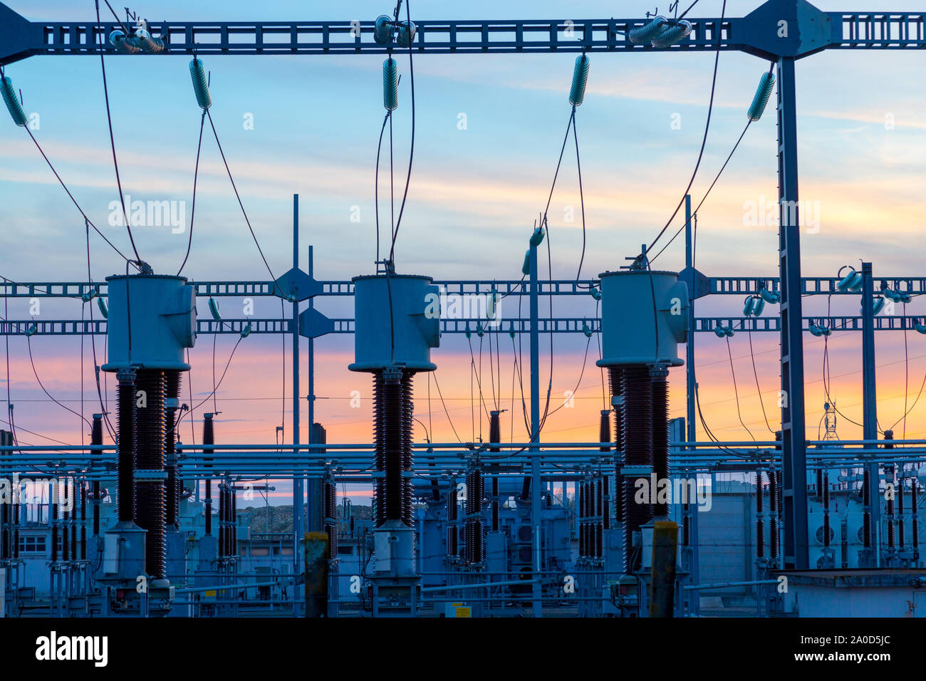 high-voltage power lines at electricity distribution station with ...