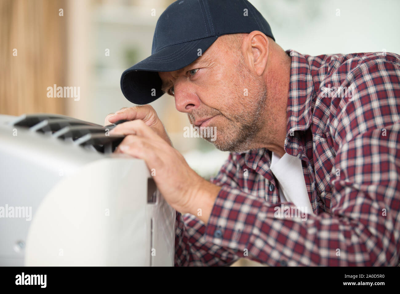 male fixing an oil heater Stock Photo - Alamy