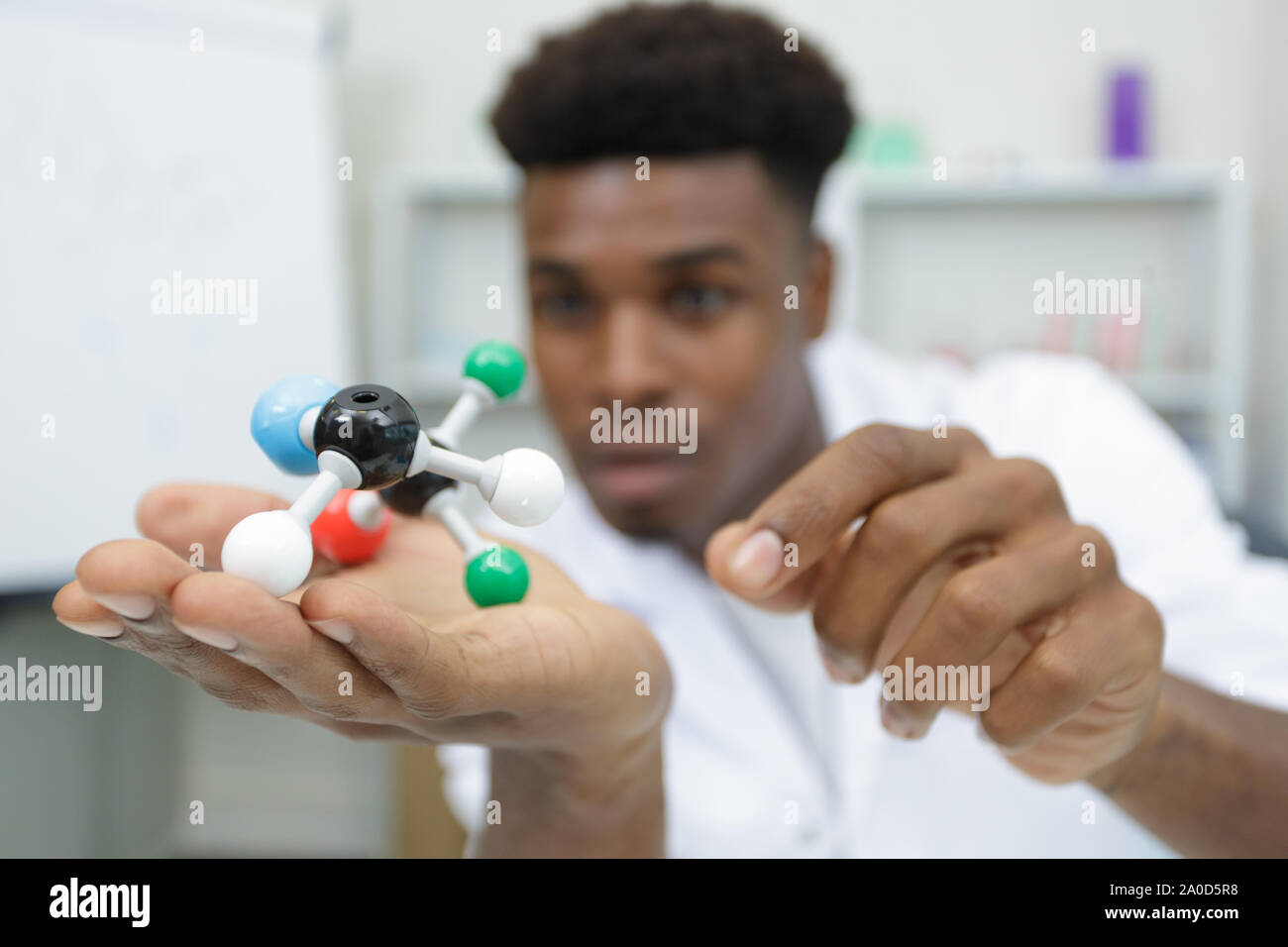 young man works on a model of molecule Stock Photo - Alamy