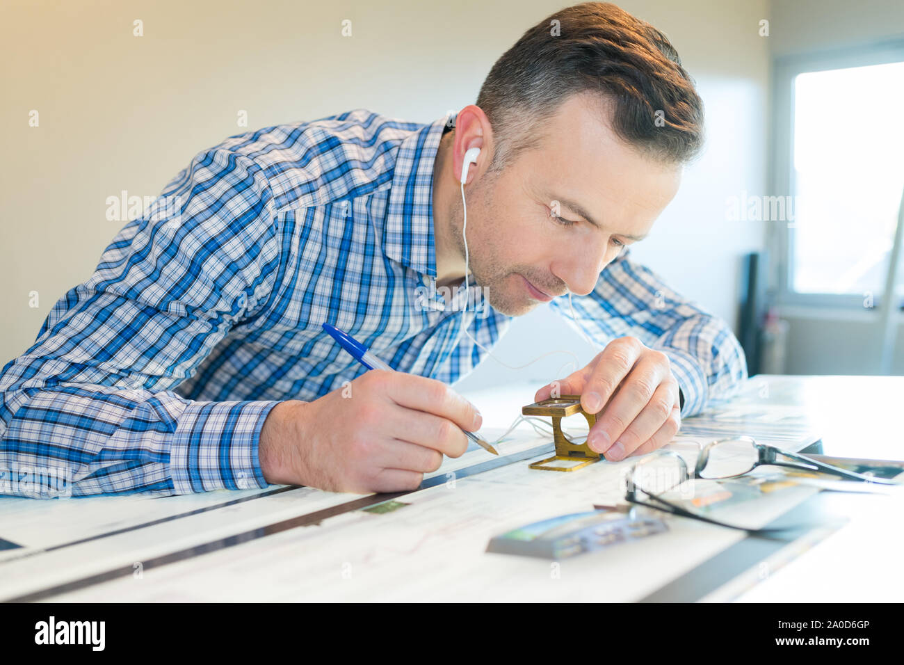 printing press worker using precise magnifying glass Stock Photo - Alamy