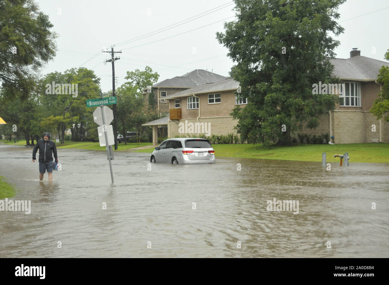 Houston, Texas, USA. 19th Sep, 2019. A motorist walks in floodwaters ...