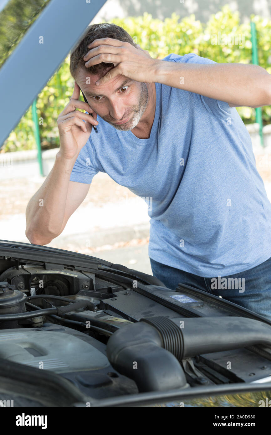 upset man calling roadside assistance after breaking down Stock Photo - Alamy