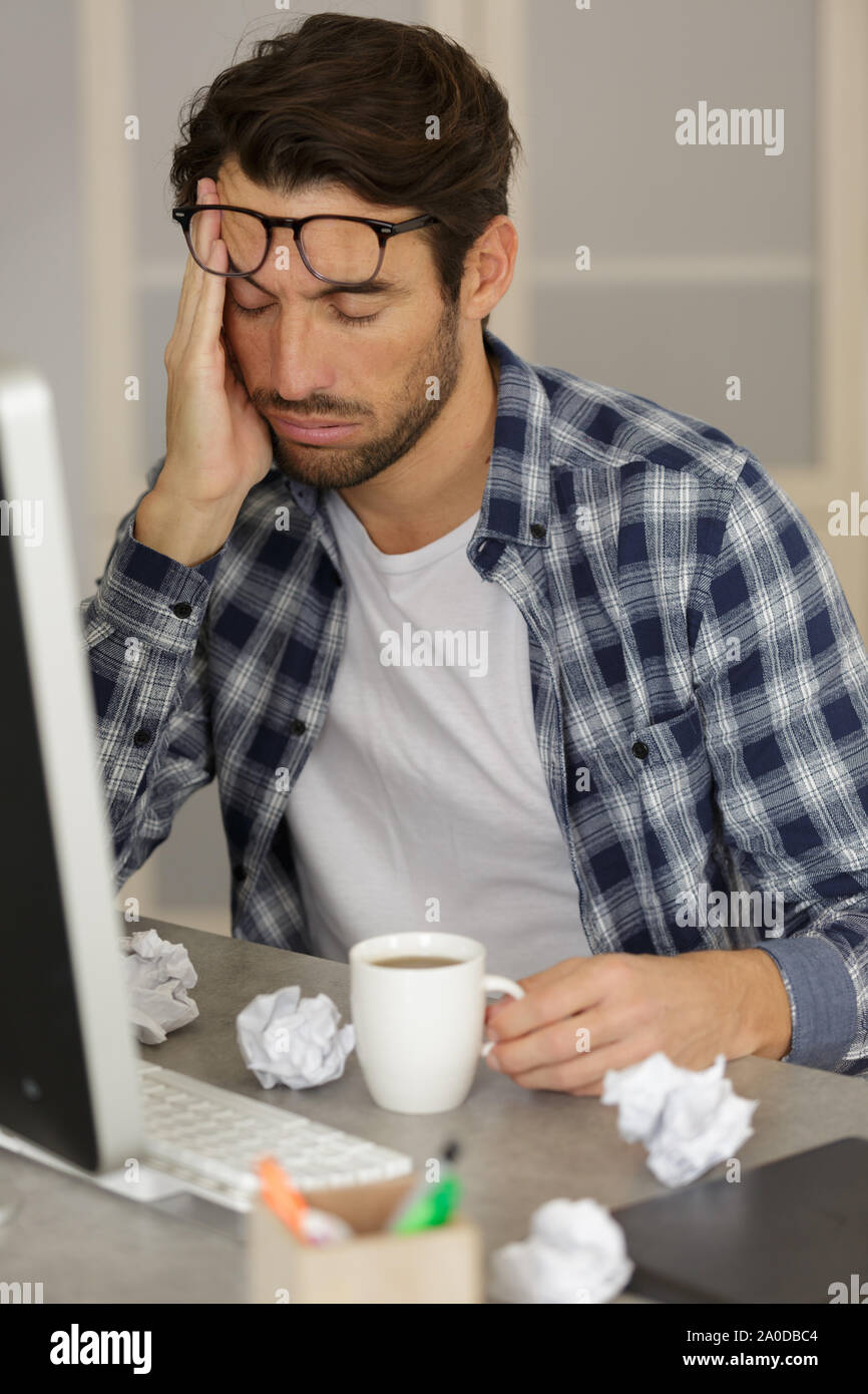 yawning graphic designer falling asleep Stock Photo - Alamy