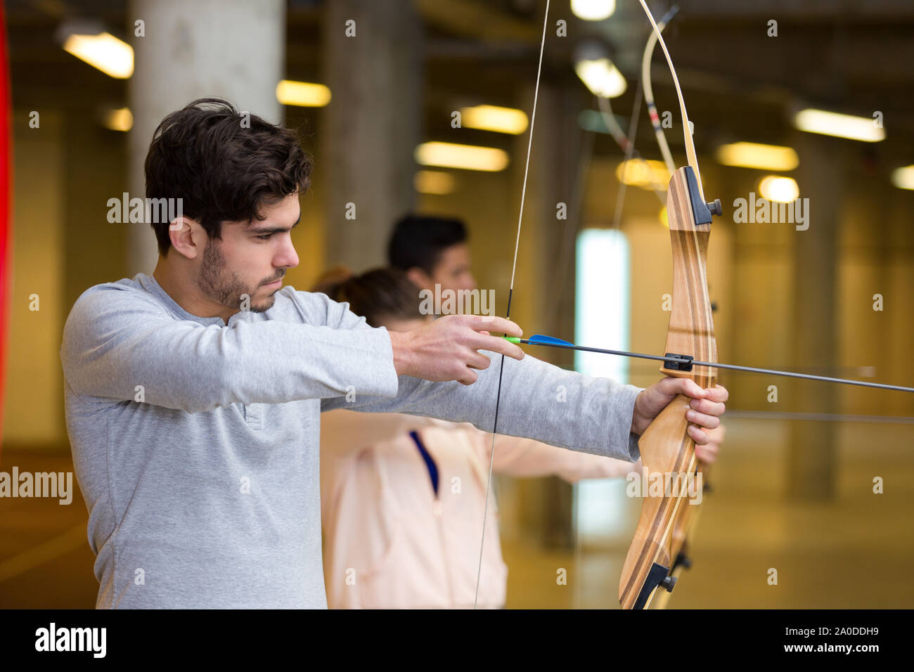 portrait of synchronize archery aiming Stock Photo - Alamy