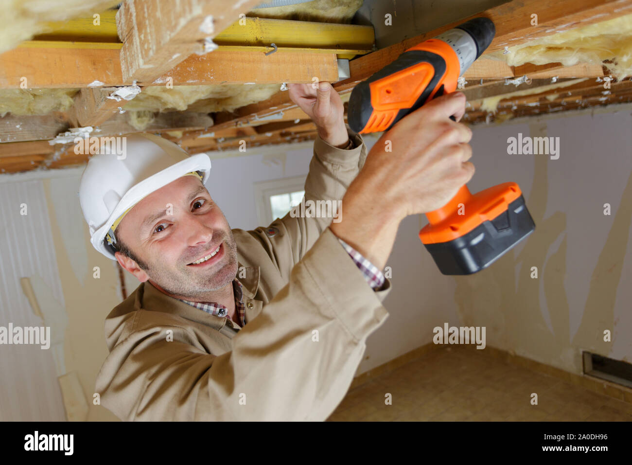 construction worker drilling a wood structure Stock Photo - Alamy