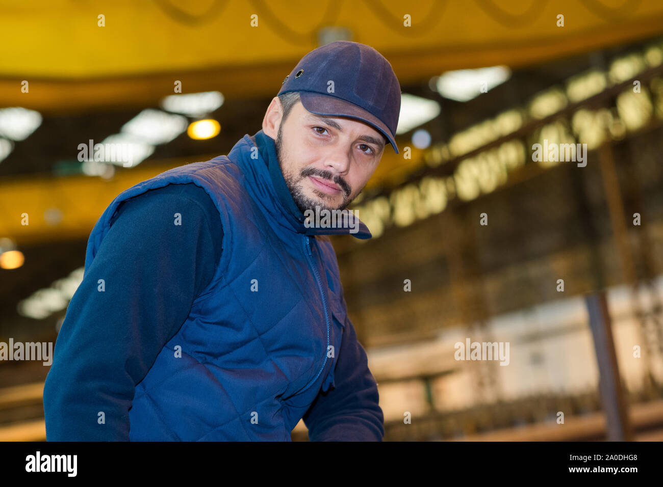 happy man in cap at warehouse Stock Photo - Alamy