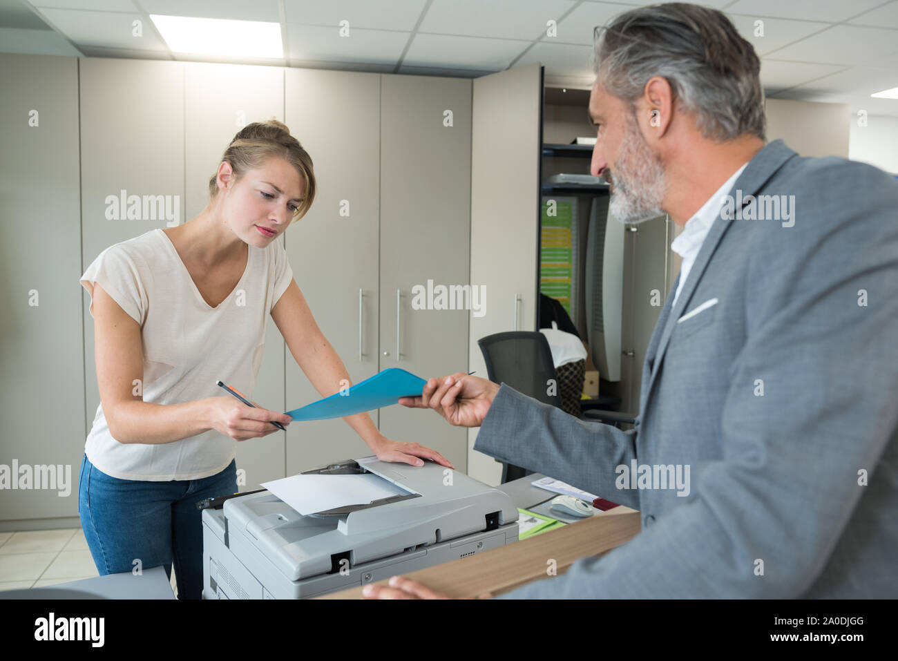 two workers checking paper work Stock Photo - Alamy