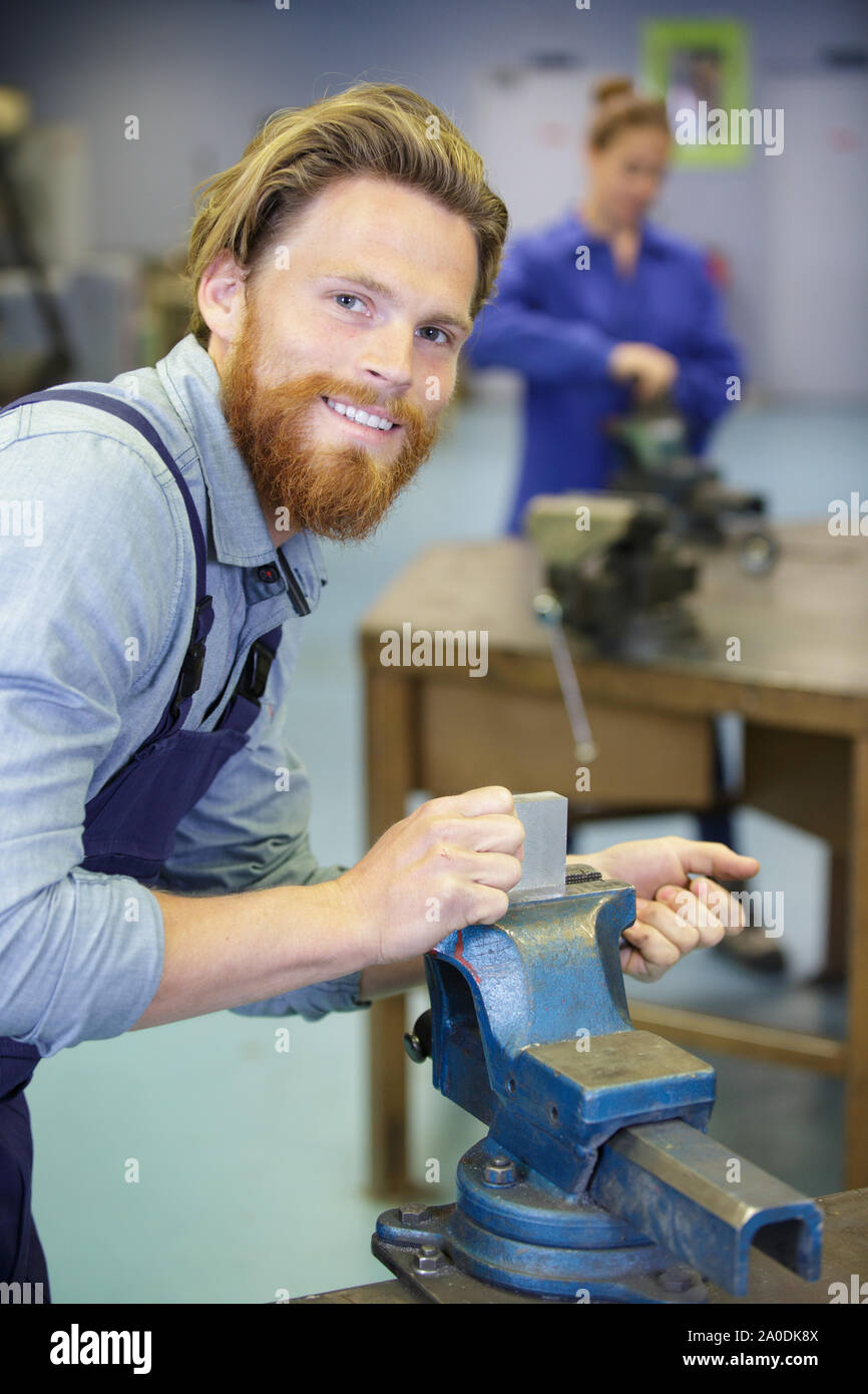 man repairing a metal object in factory Stock Photo - Alamy