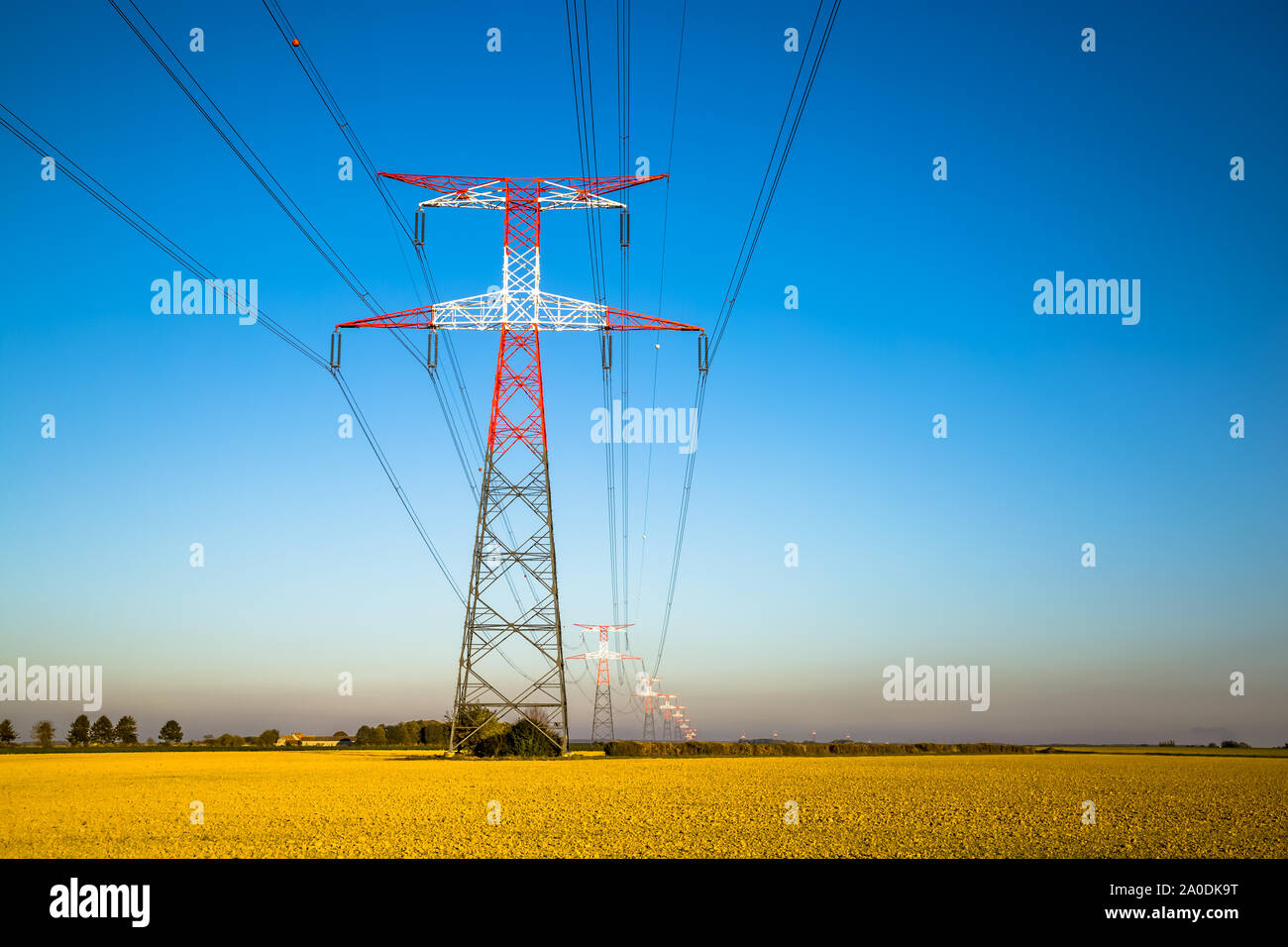 Electricity transmission pylon silhouetted against blue Stock Photo - Alamy