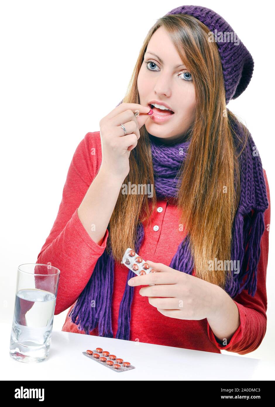 cute girl taking drug against a white background Stock Photo - Alamy