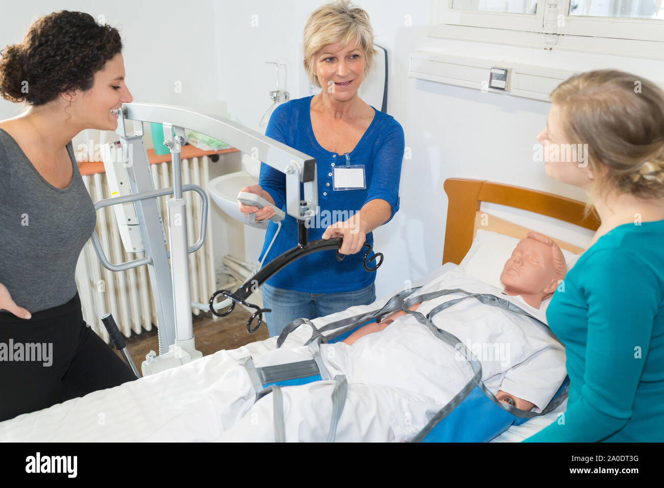 nurses lifting a dummy on bed Stock Photo - Alamy