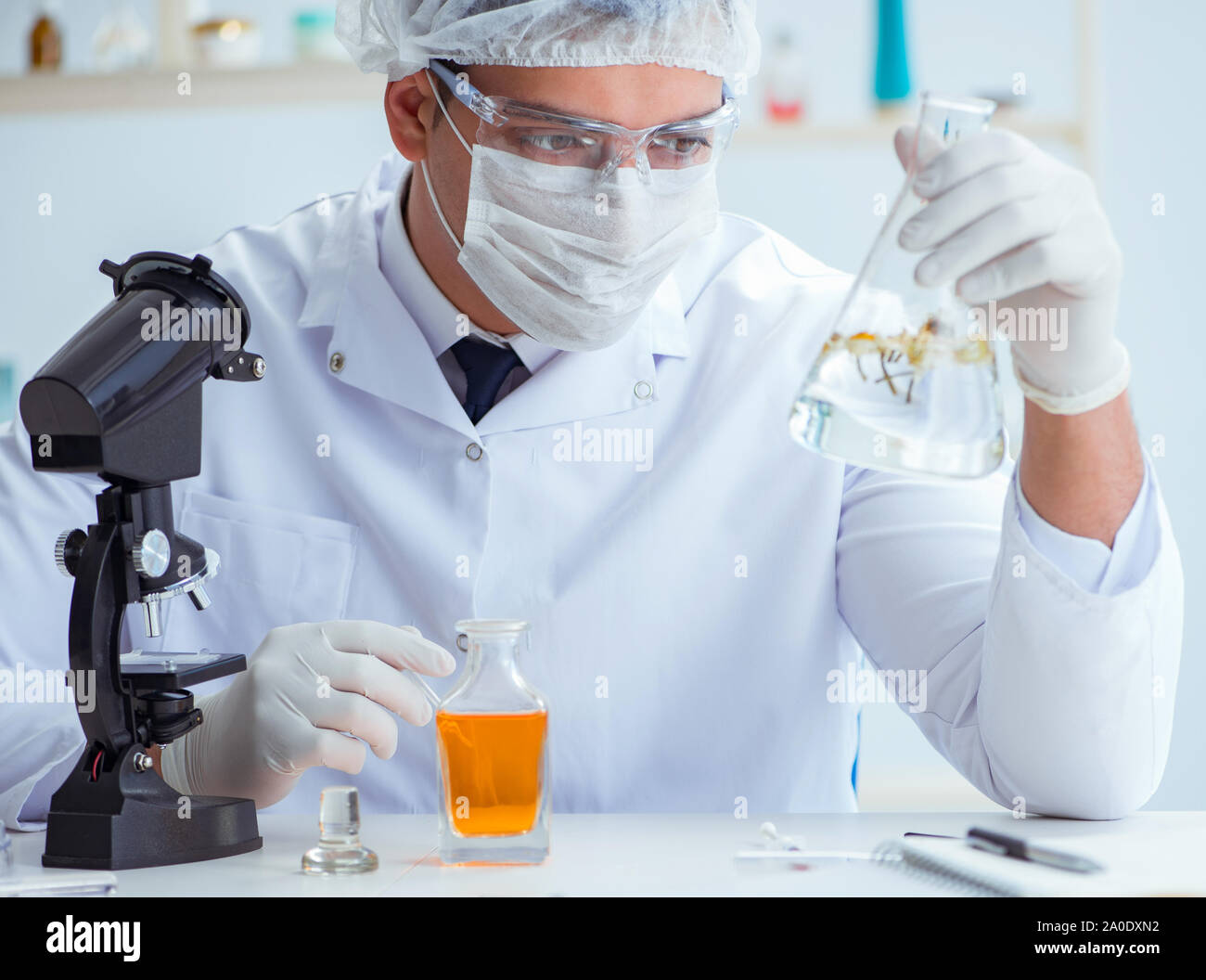 The chemist mixing perfumes in the lab Stock Photo - Alamy