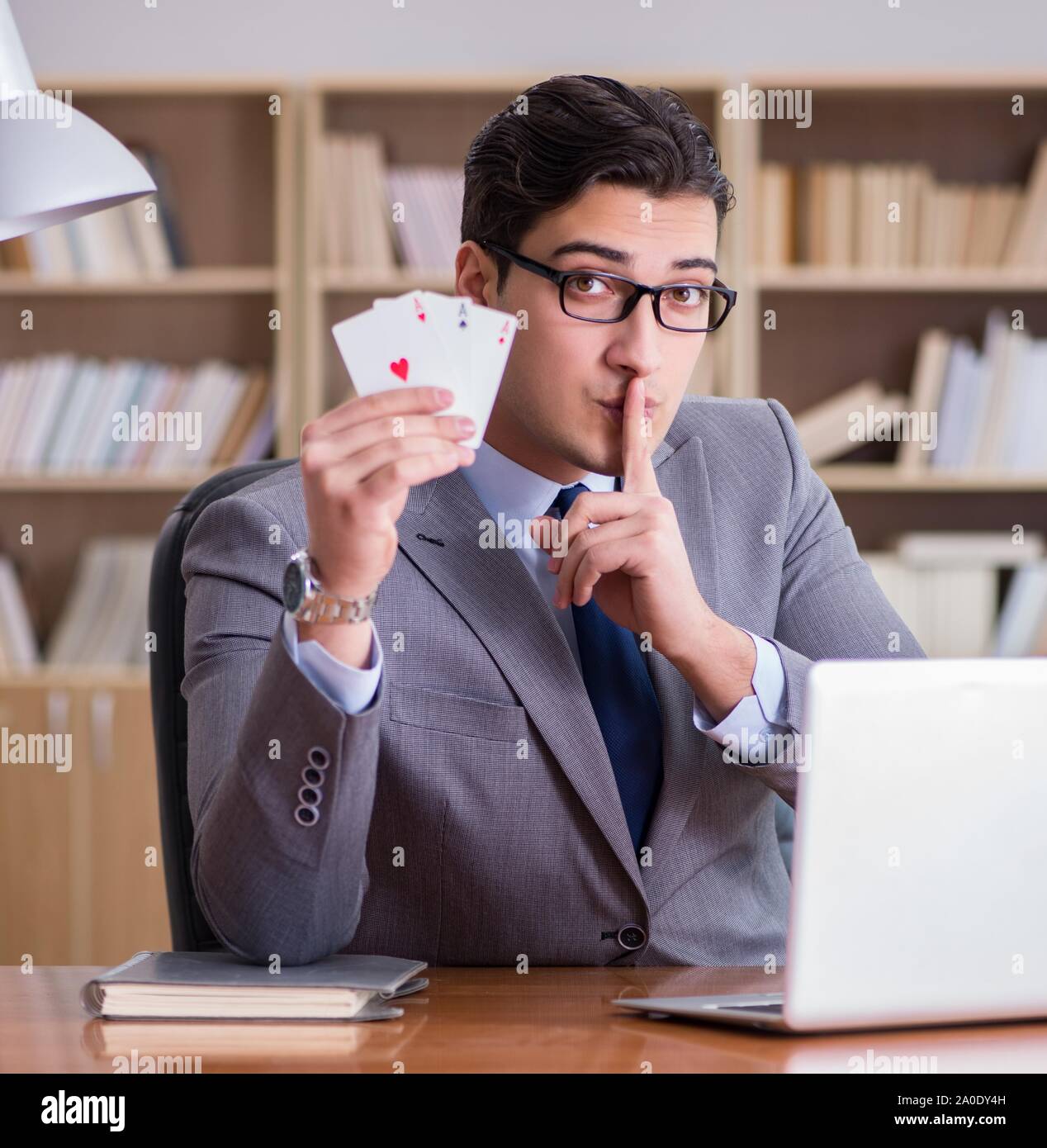 The businessman gambling playing cards at work Stock Photo - Alamy