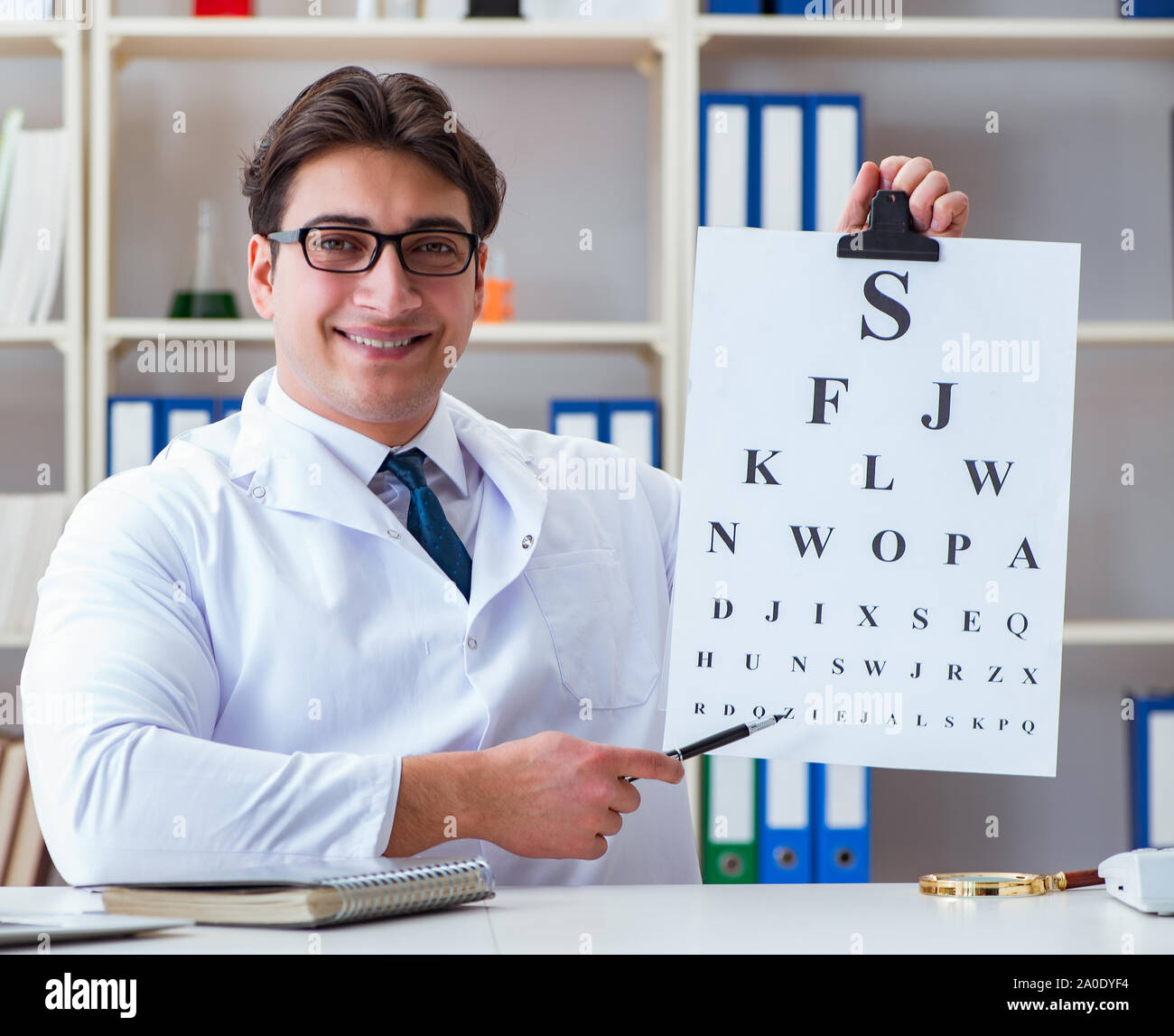 The doctor optician with letter chart conducting an eye test check ...