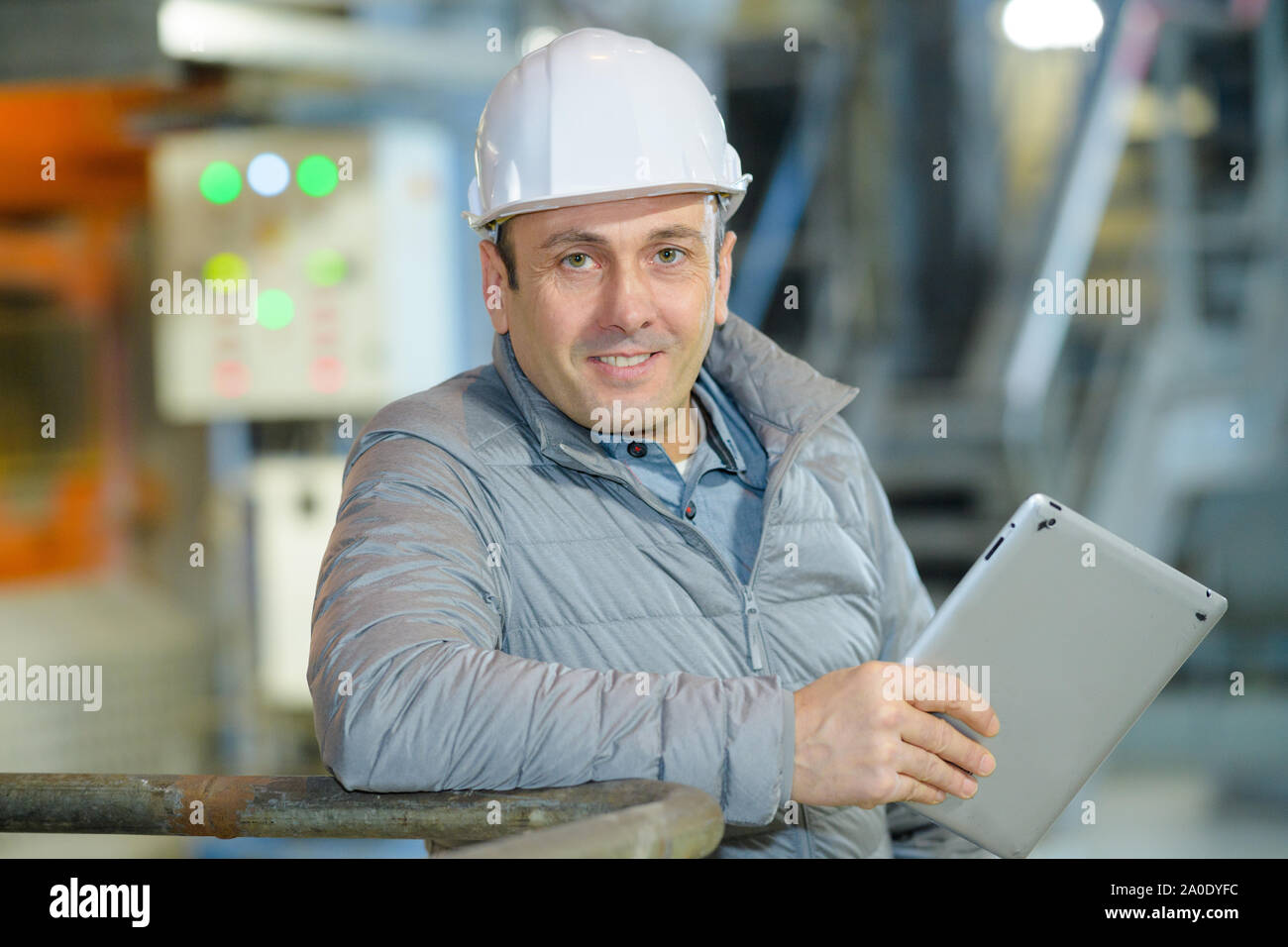 male industrial worker posing holding tablet Stock Photo - Alamy