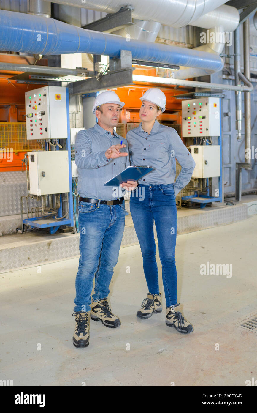 engineers working in temperature control room of large building Stock ...