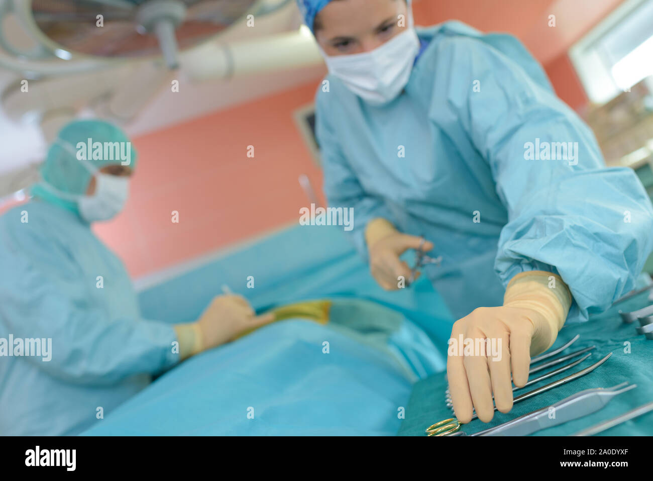 medical worker reaching for instrument during operation Stock Photo - Alamy