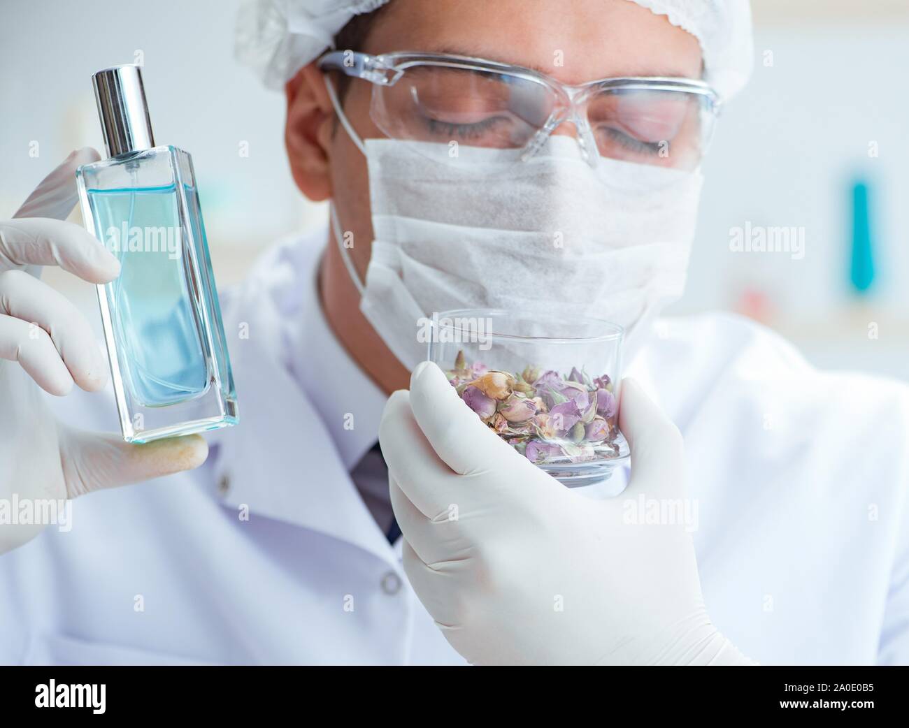 The chemist mixing perfumes in the lab Stock Photo - Alamy