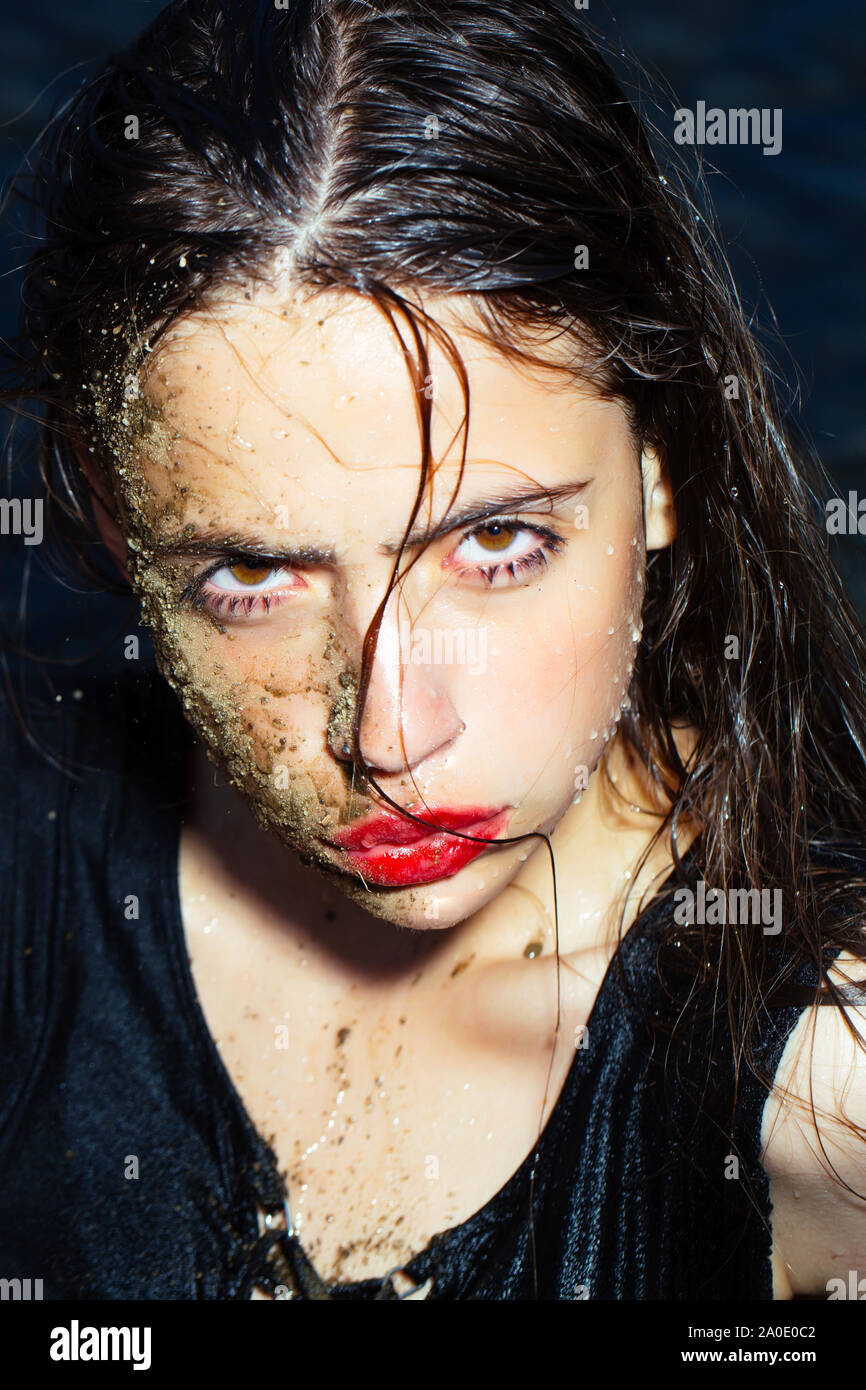 Caucasian fashion model with brunette hair posing in water, wet face ...