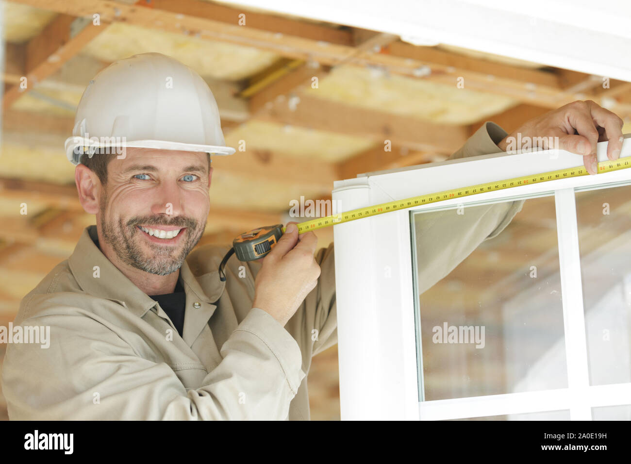 happy worker inspecting a window sill Stock Photo - Alamy